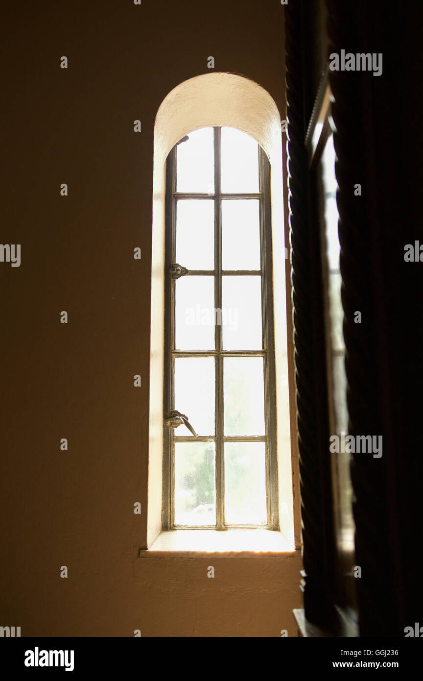 Light seen through a thin arched window at the Cathedral of Learning in ...