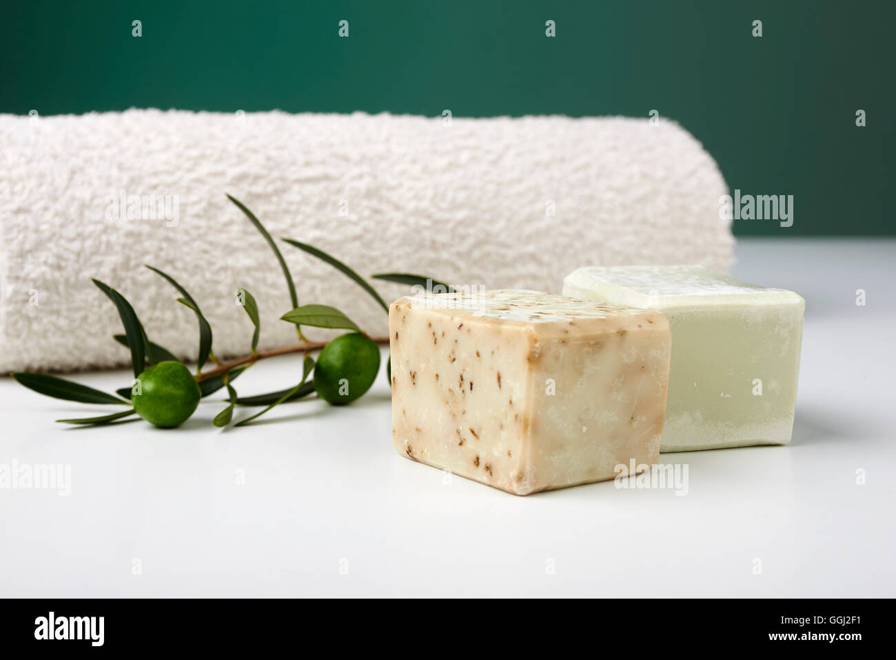 Handmade olive soap with olive branch and a towel Stock Photo - Alamy