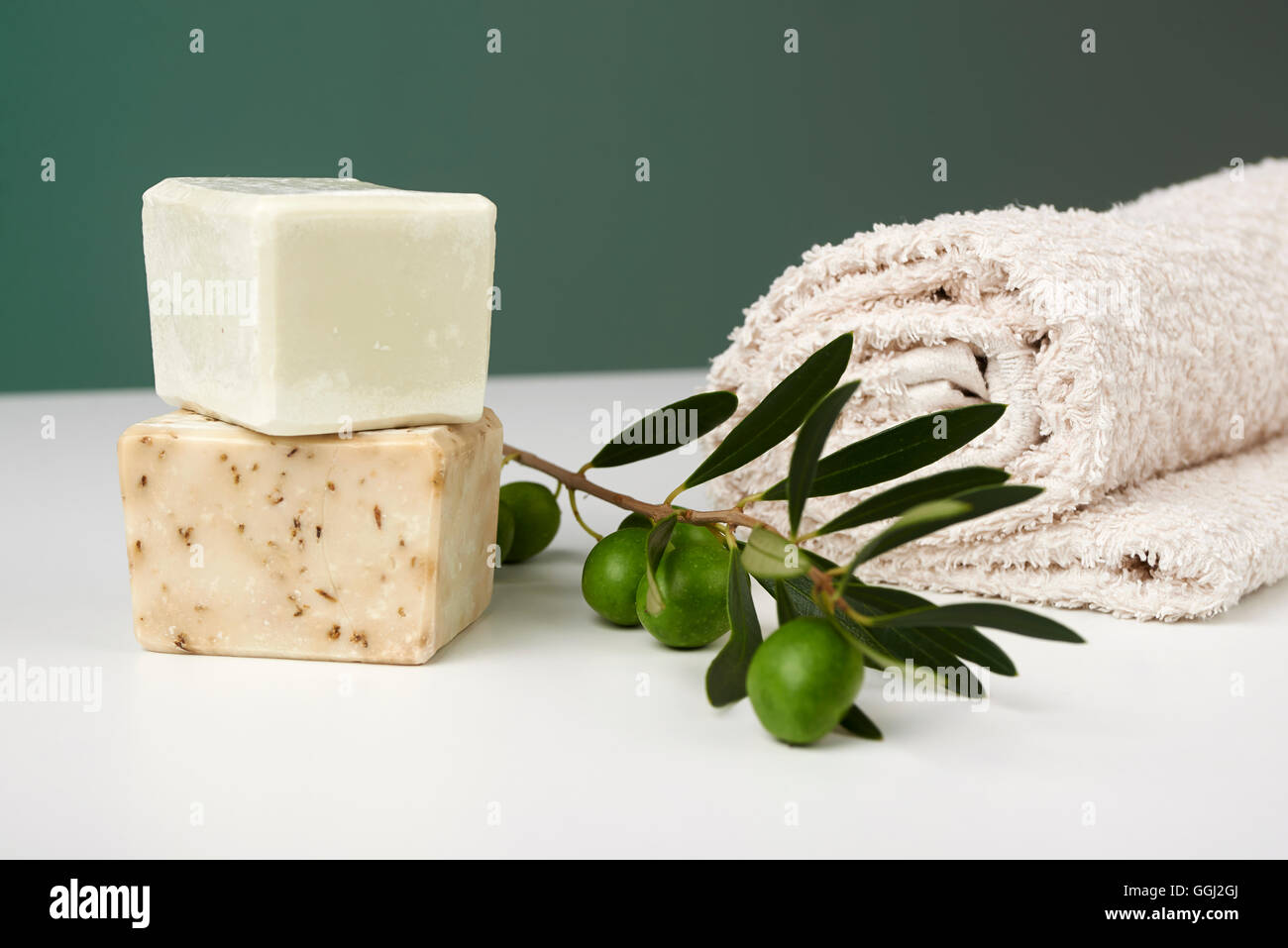 Handmade olive soap with olive branch and a towel Stock Photo - Alamy