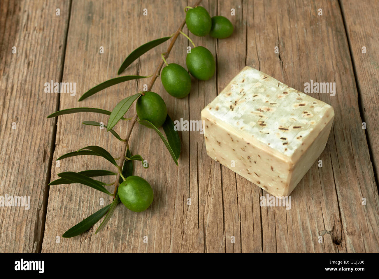 Handmade olive soap with olive branch on wooden table Stock Photo - Alamy
