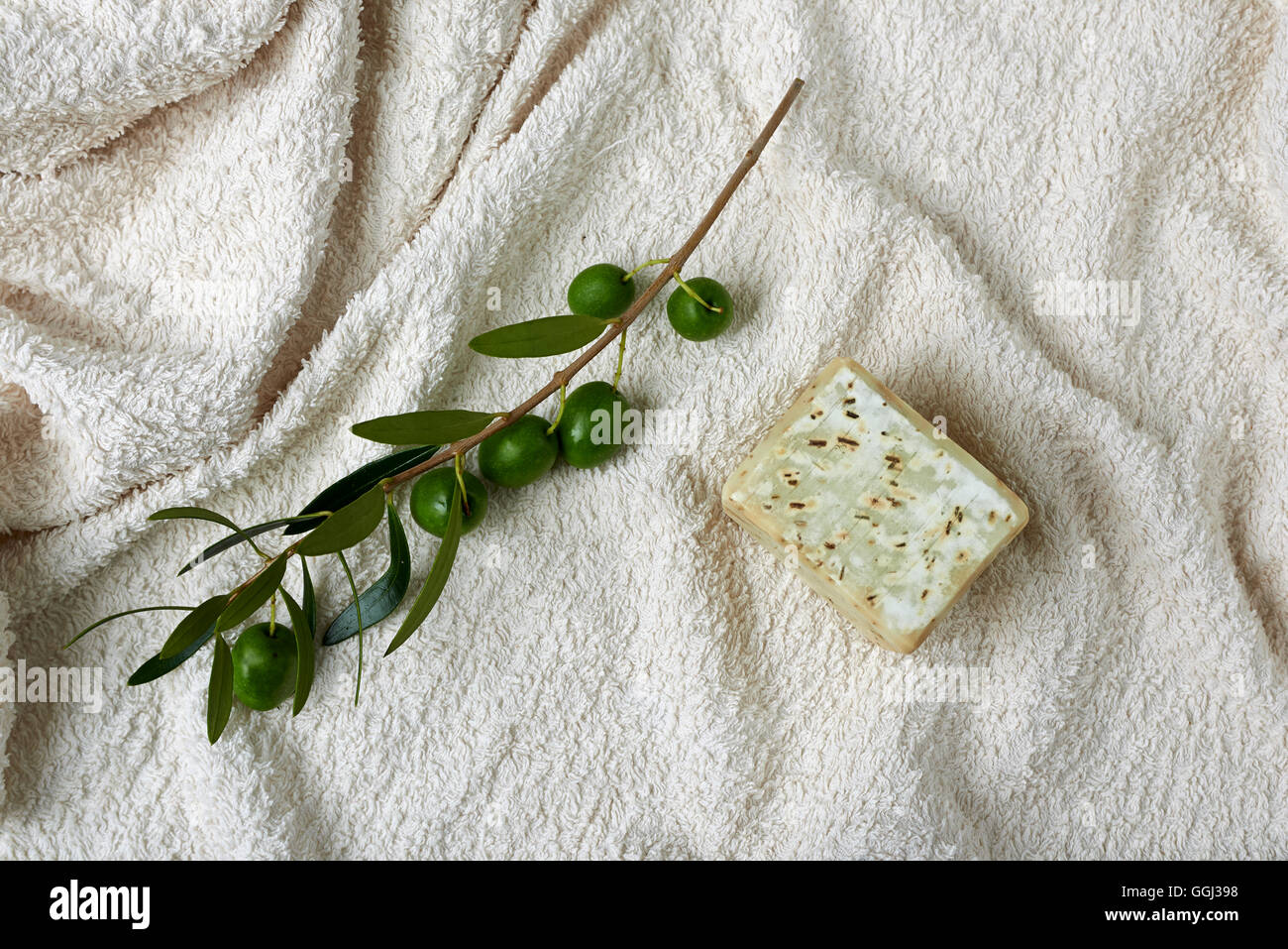 Handmade olive soap with olive branch and a towel Stock Photo - Alamy