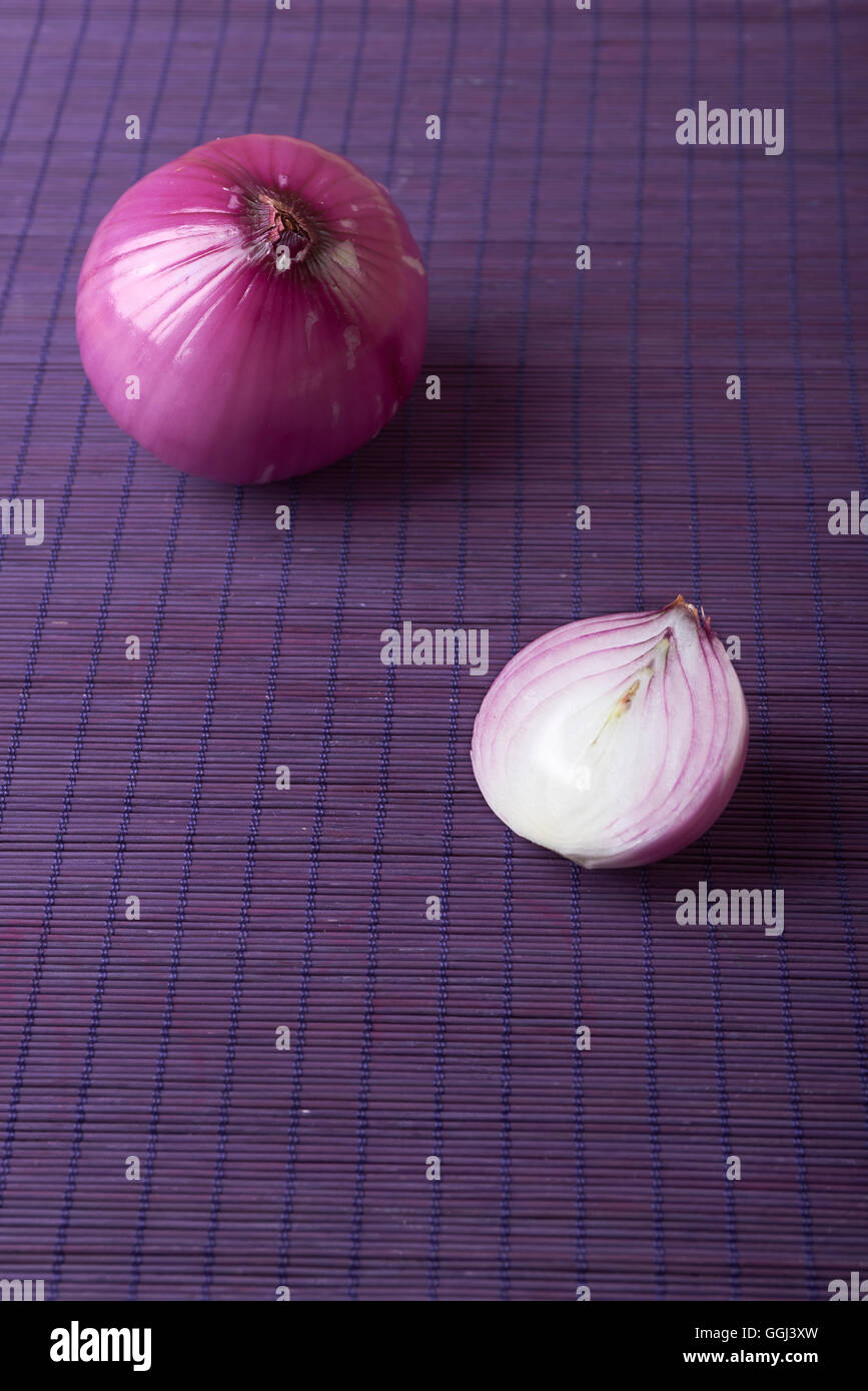 purple onions on purple background Stock Photo - Alamy