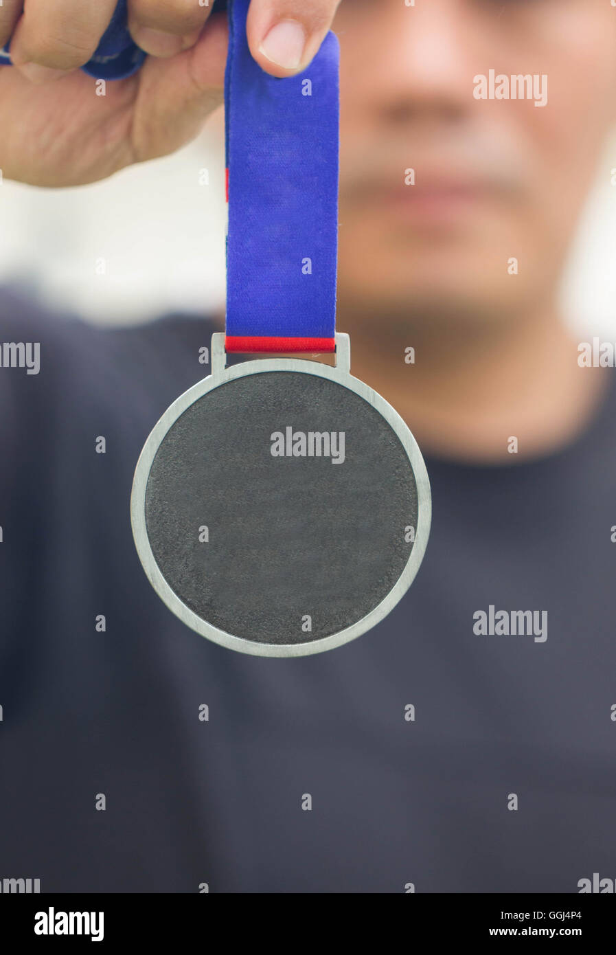 Athlete Holding Generic Gold Medal With Ribbon On His Hand Stock Photo ...
