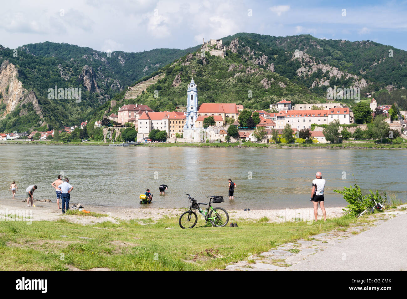 People enjoying and relaxing on shore of Danube river in Durnstein ...