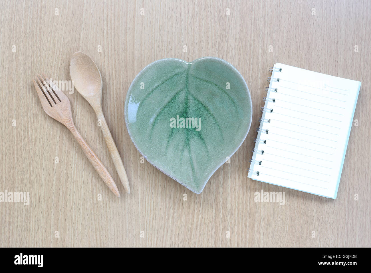 kitchen utensils and note book on wood background for design Concept in ...