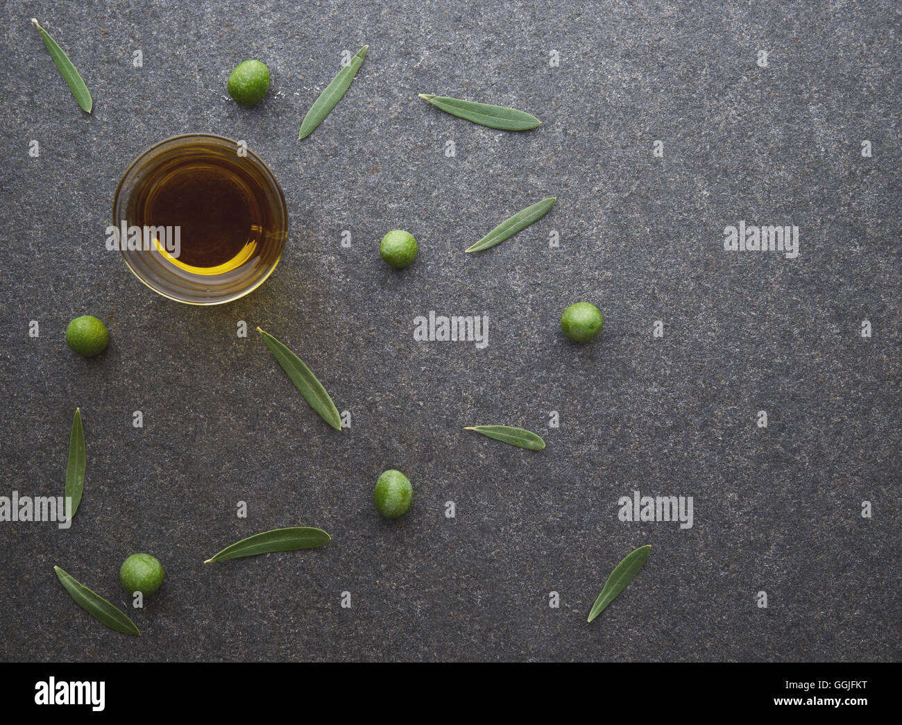 Raw olives on black marble Stock Photo - Alamy