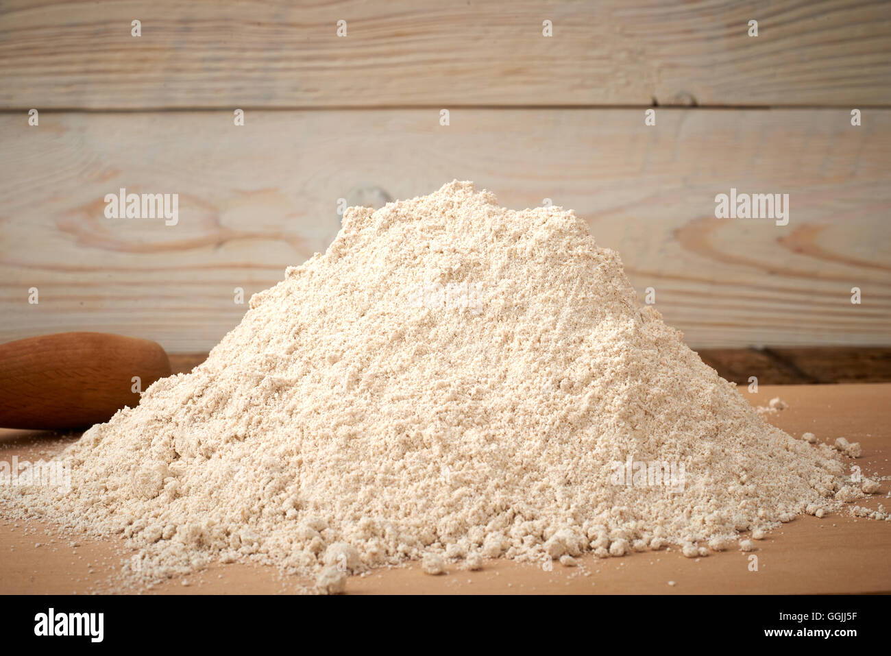 white flour on a wooden kitchen table Stock Photo - Alamy