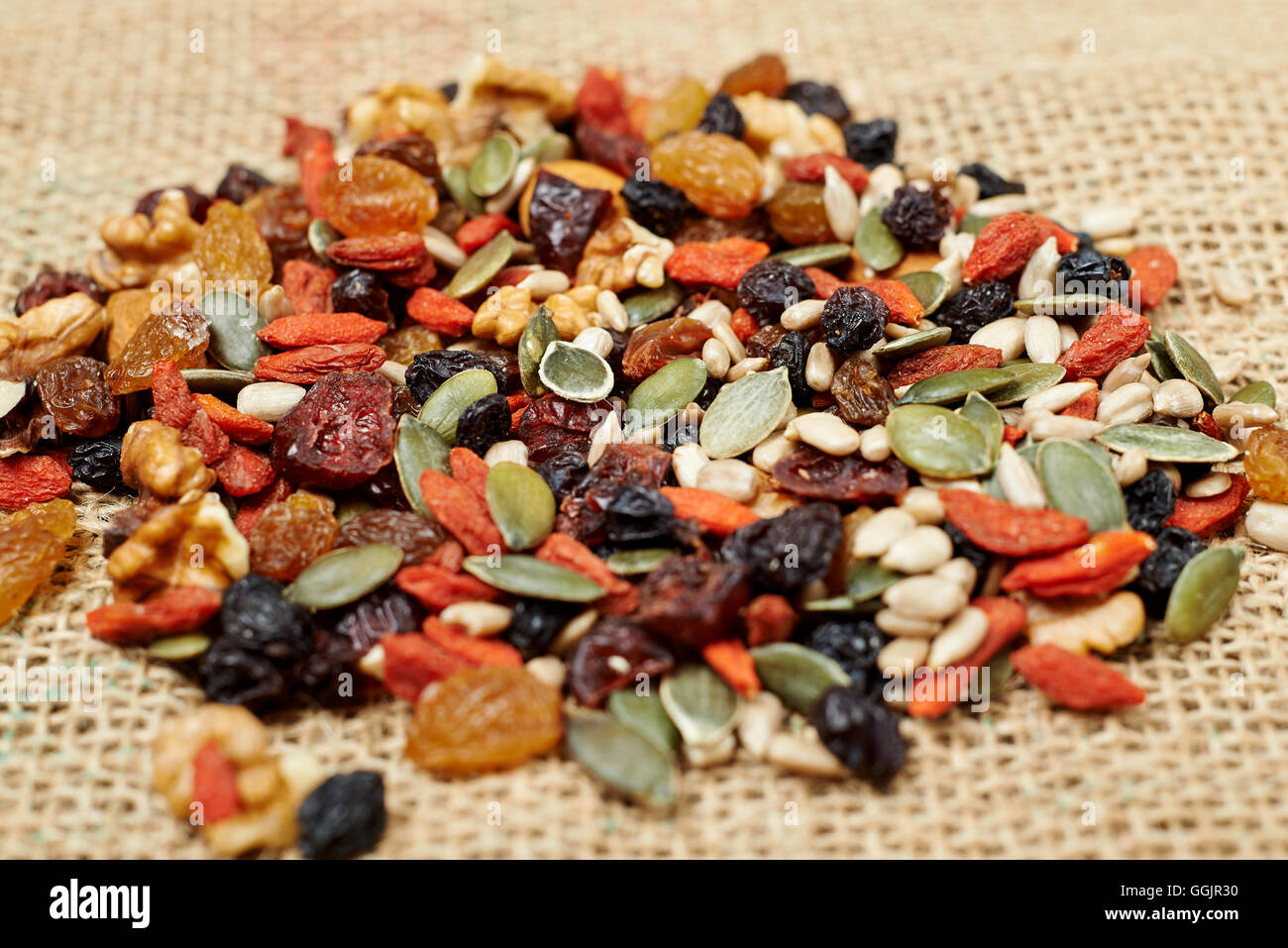 mix nuts seeds and dry fruits, on a wooden table Stock Photo - Alamy