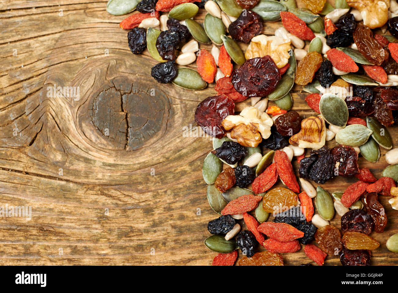 mix nuts seeds and dry fruits, on a wooden table Stock Photo - Alamy