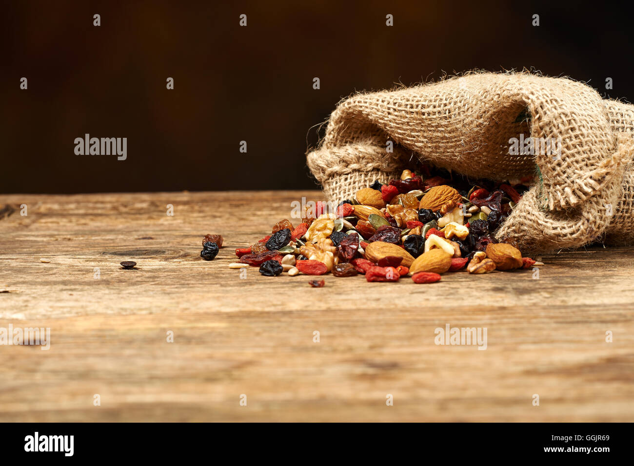 mix nuts seeds and dry fruits, on a wooden table Stock Photo - Alamy