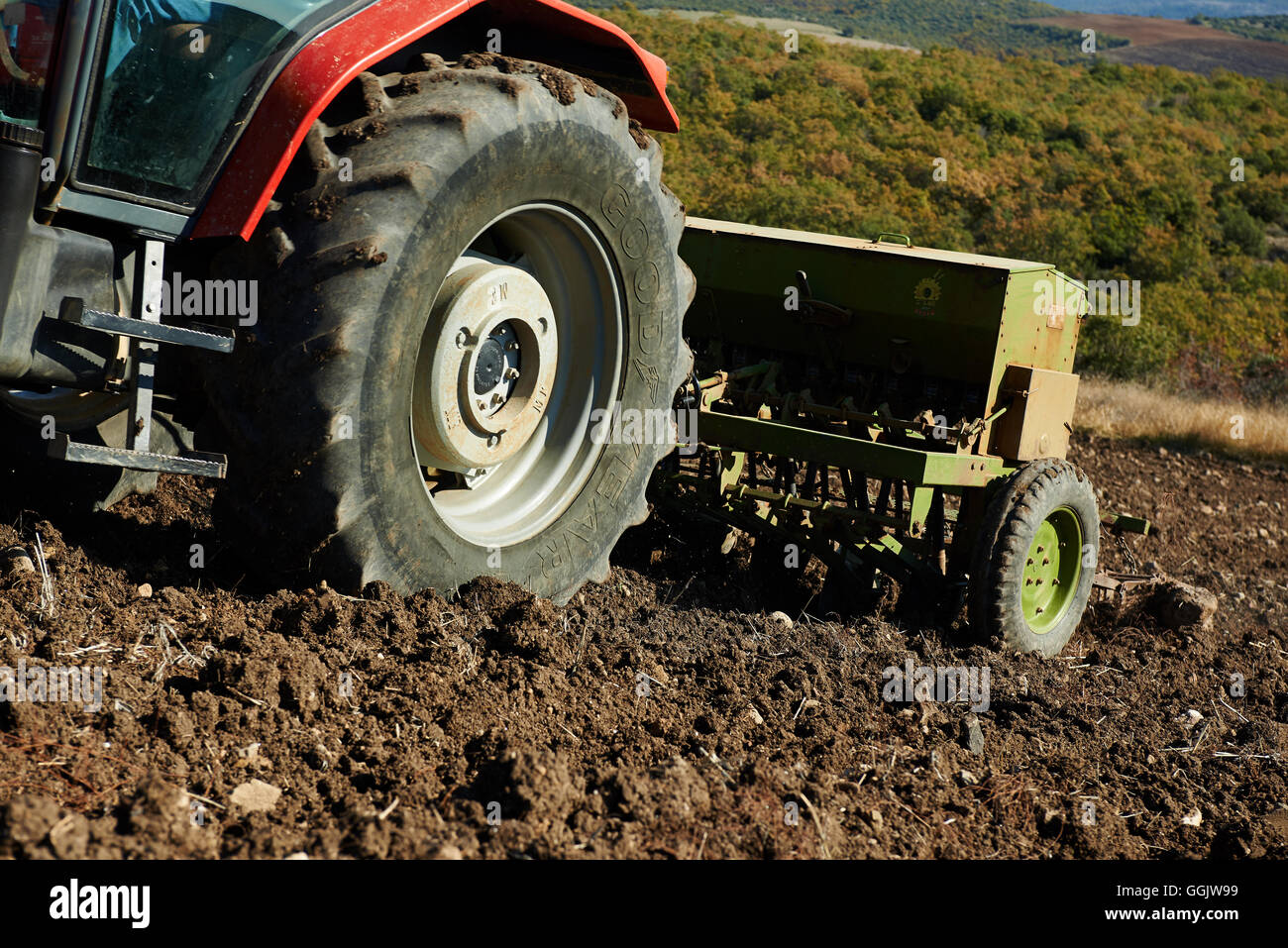 agricultural tractor sowing seeds and cultivating field Stock Photo - Alamy