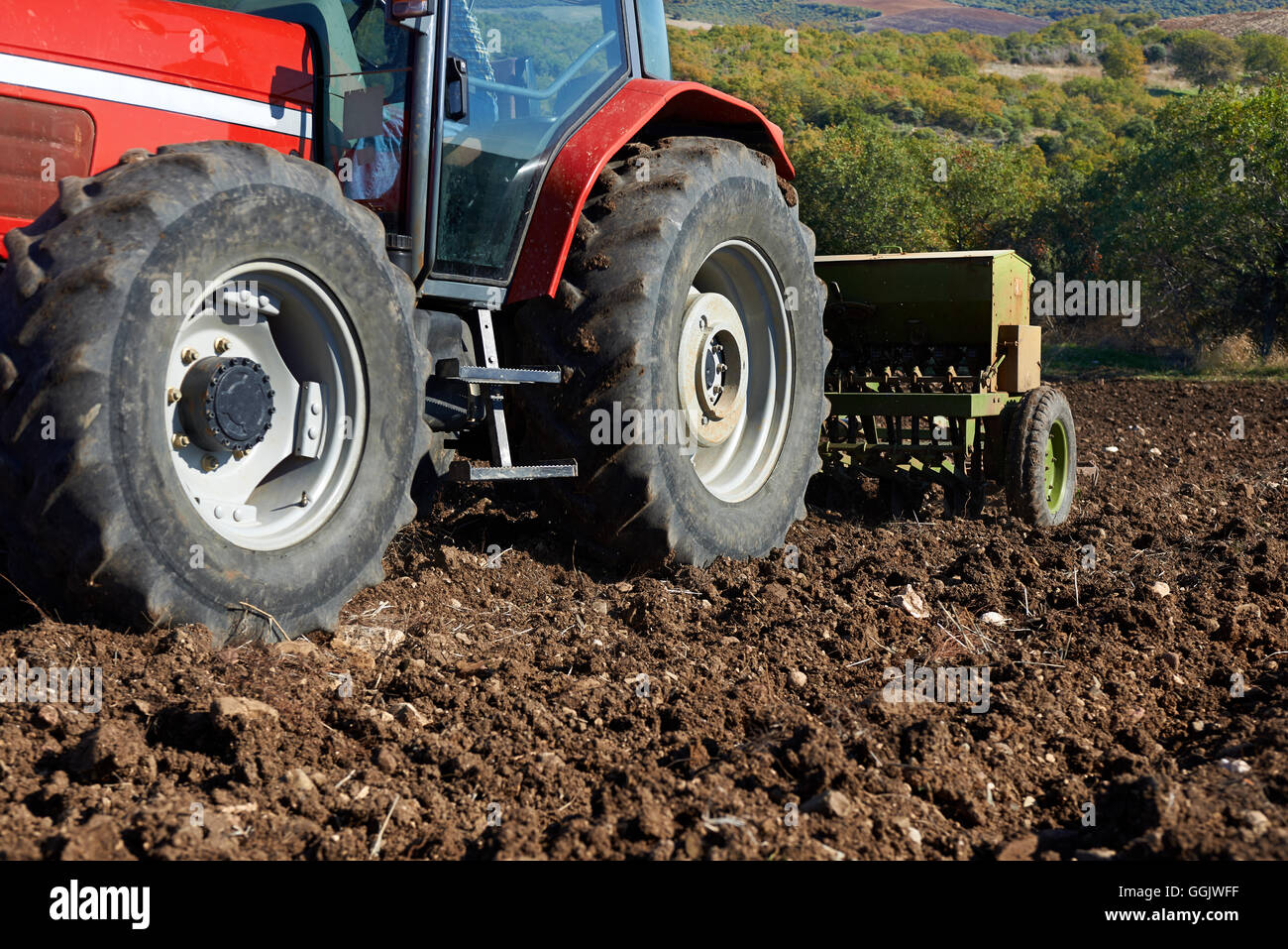 agricultural tractor sowing seeds and cultivating field Stock Photo - Alamy