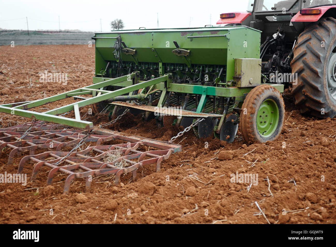 agricultural tractor sowing seeds and cultivating field Stock Photo - Alamy