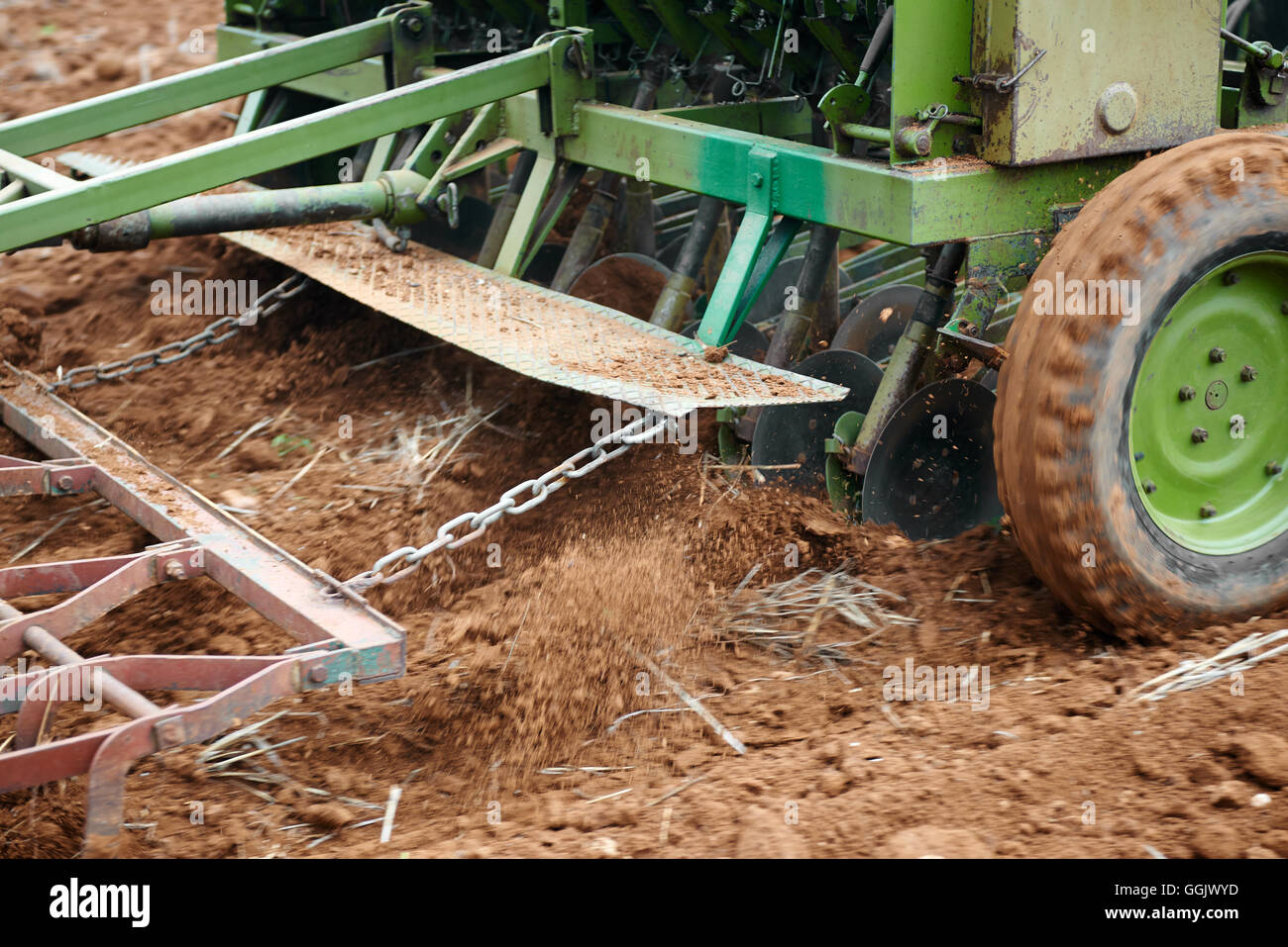 agricultural tractor sowing seeds and cultivating field Stock Photo - Alamy