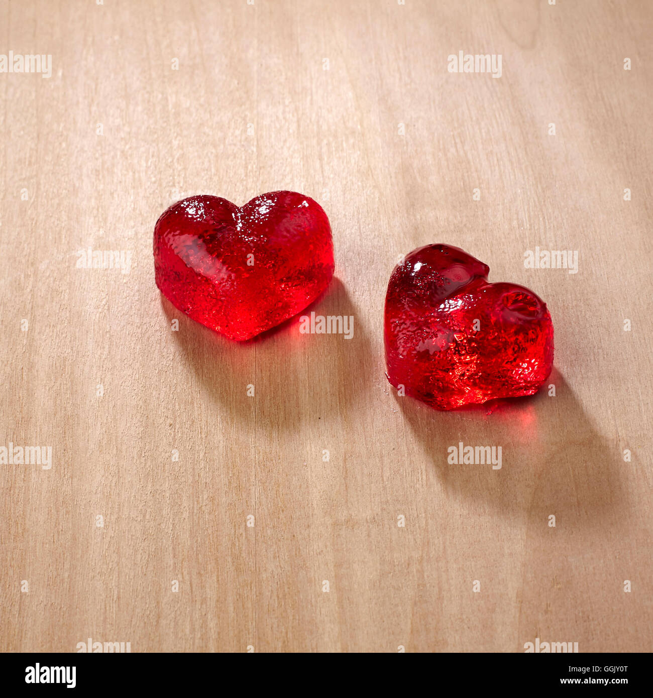 Valentines day, red sweet candies in heart shape, on wooden background ...