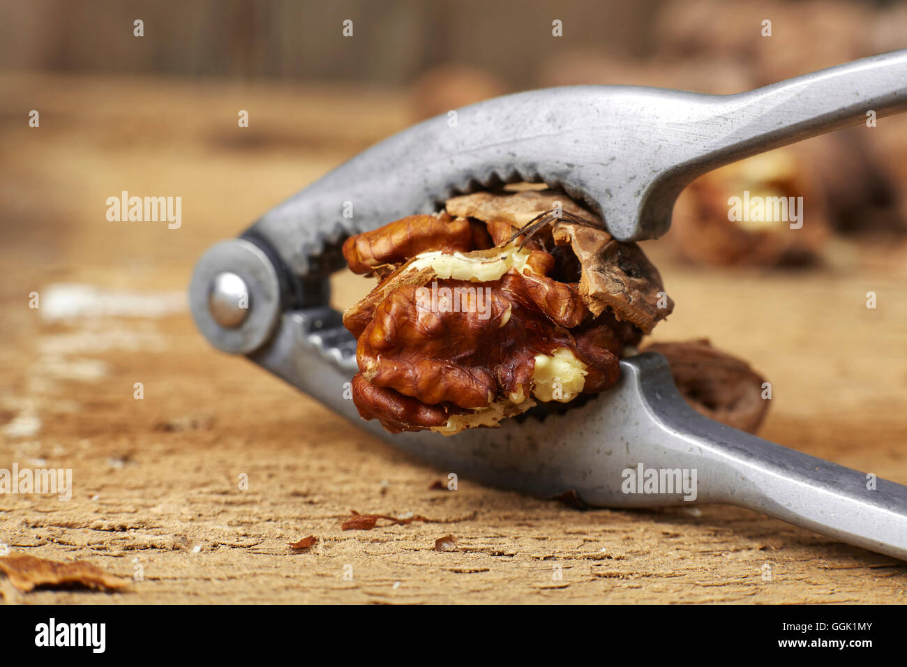 walnuts cracked open with a vintage nut cracker Stock Photo - Alamy