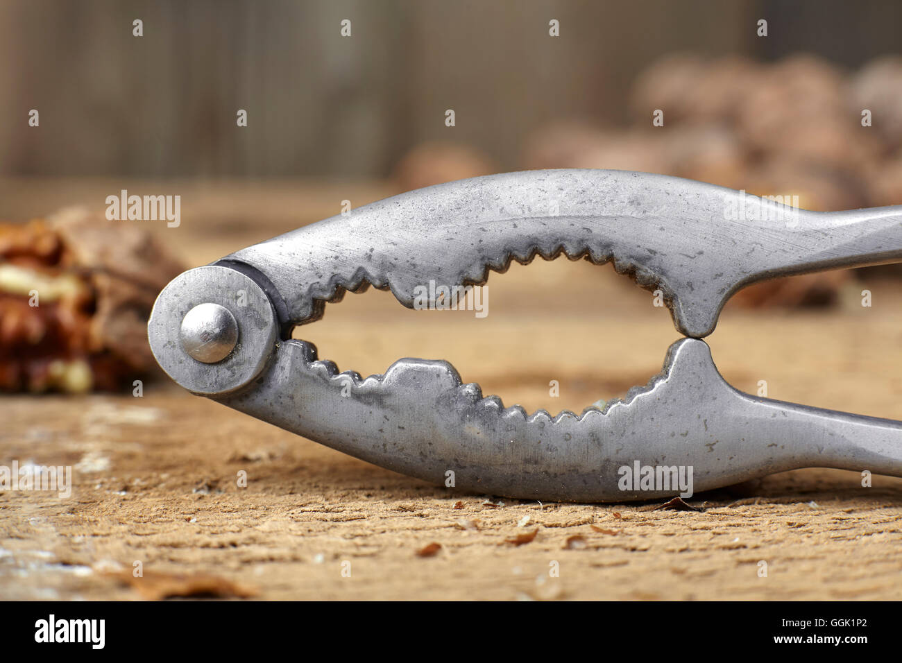 walnuts cracked open with a vintage nut cracker Stock Photo - Alamy