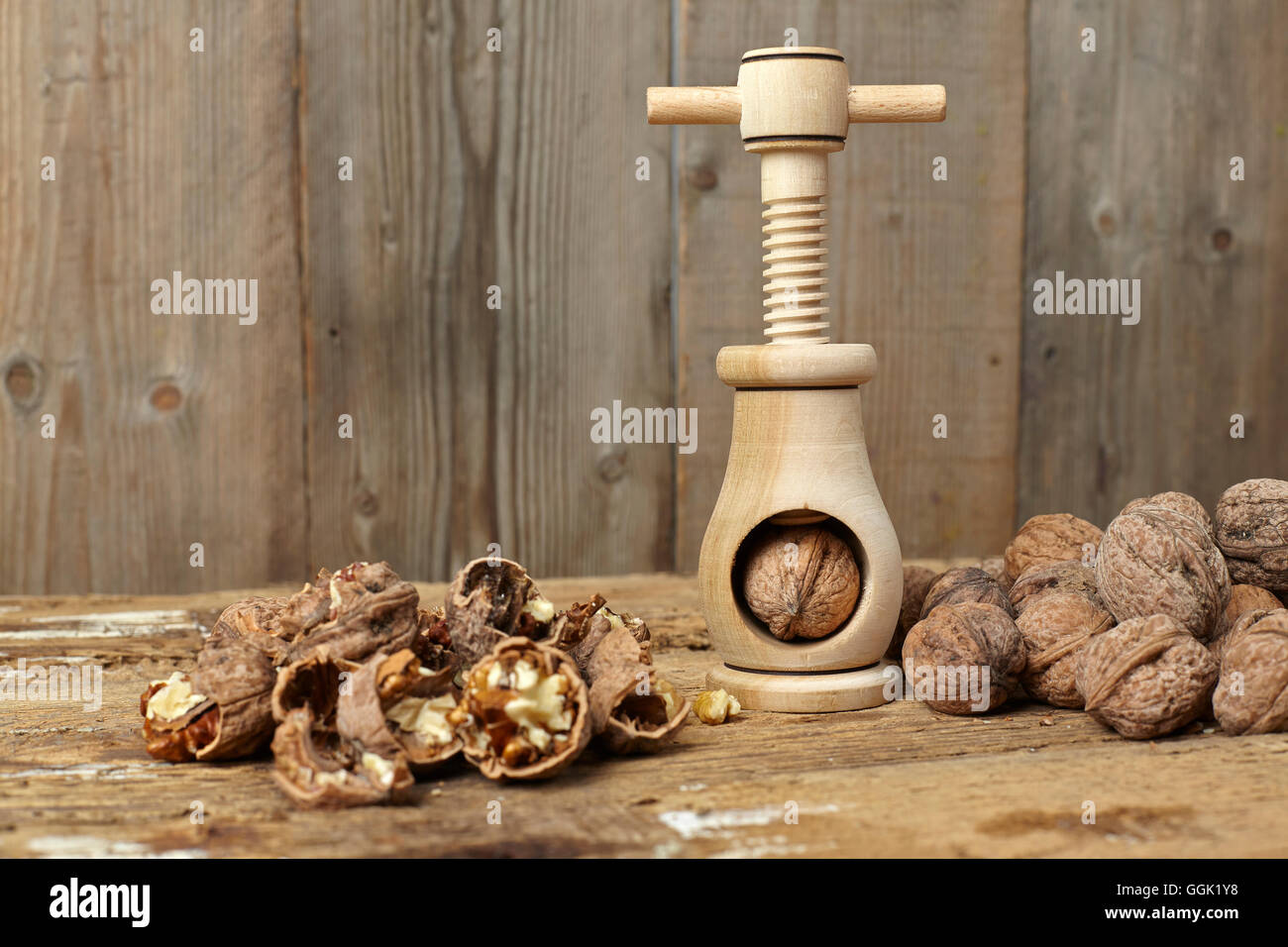 walnuts cracked open with a vintage wooden nut cracker Stock Photo - Alamy
