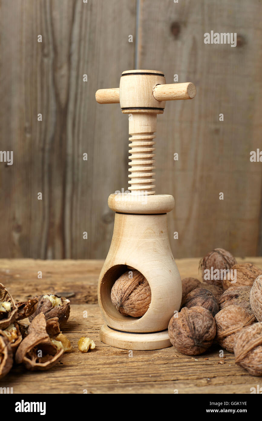 walnuts cracked open with a vintage wooden nut cracker Stock Photo - Alamy