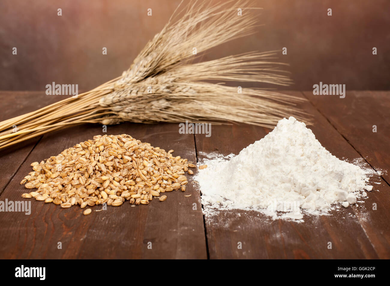 Wheat, plant seeds and flour on wooden table Stock Photo - Alamy
