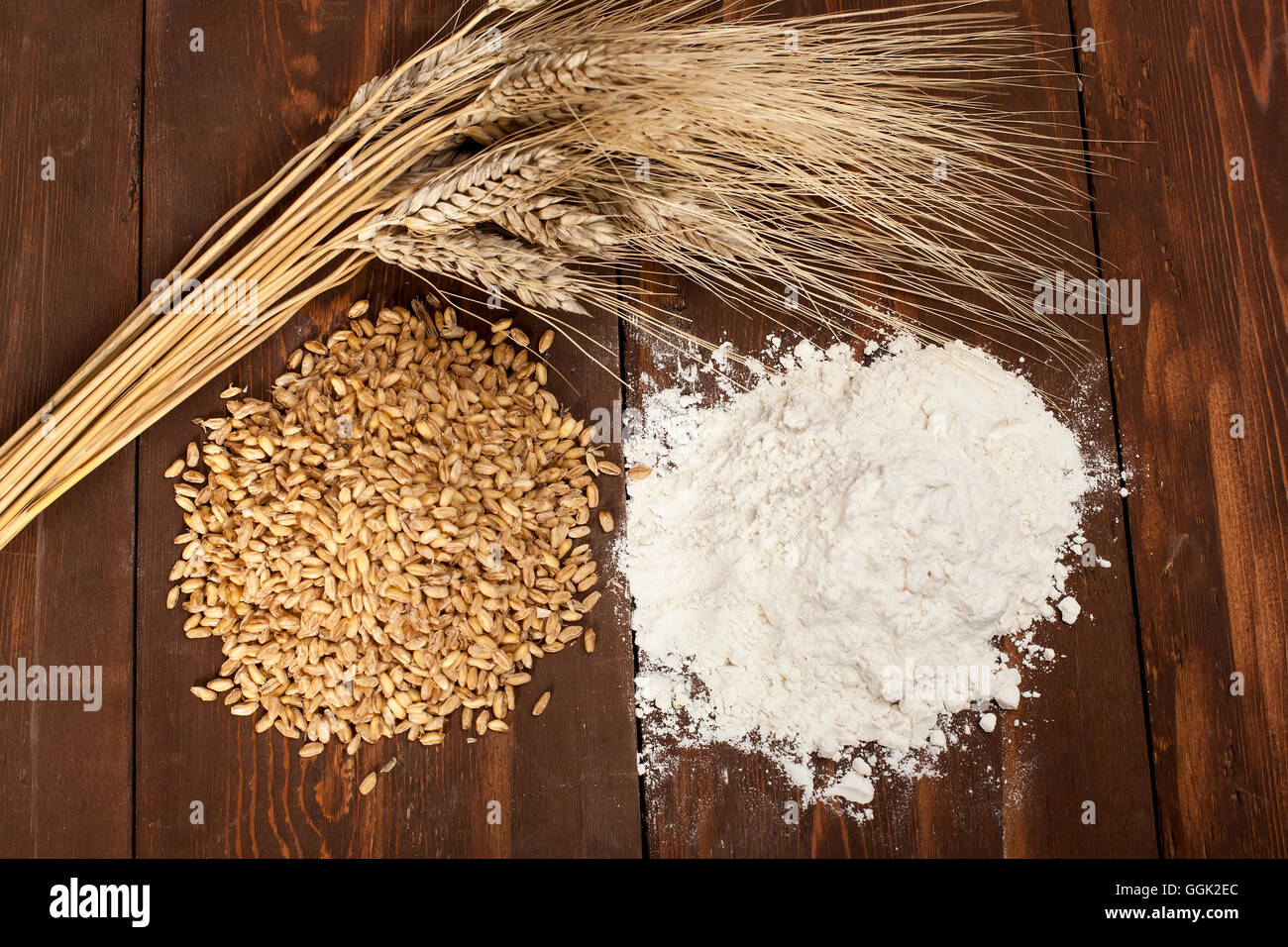 Wheat, plant seeds and flour on wooden table Stock Photo - Alamy