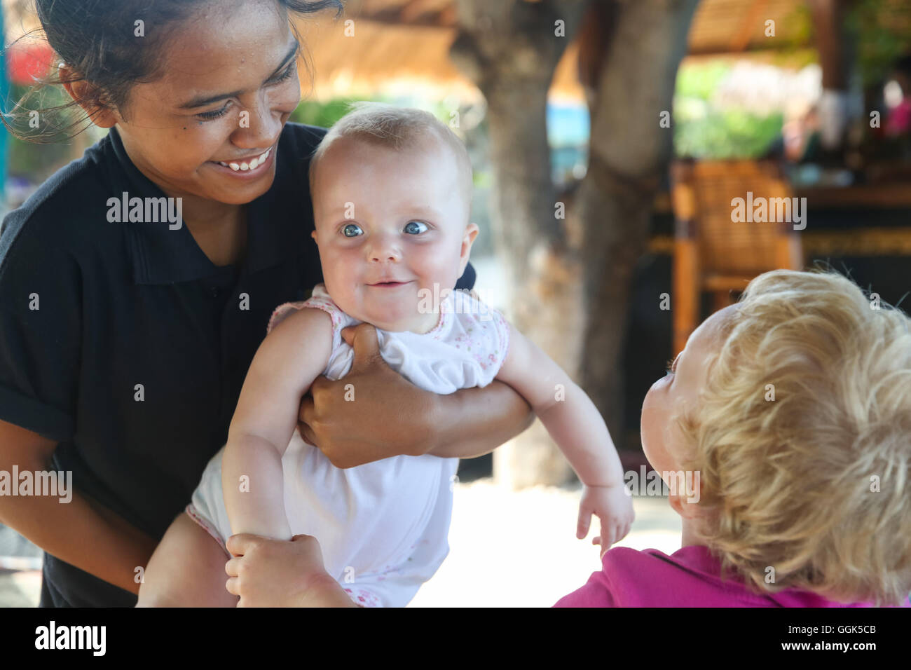 Balinese women holding German baby, laughing, smile, fond of children ...