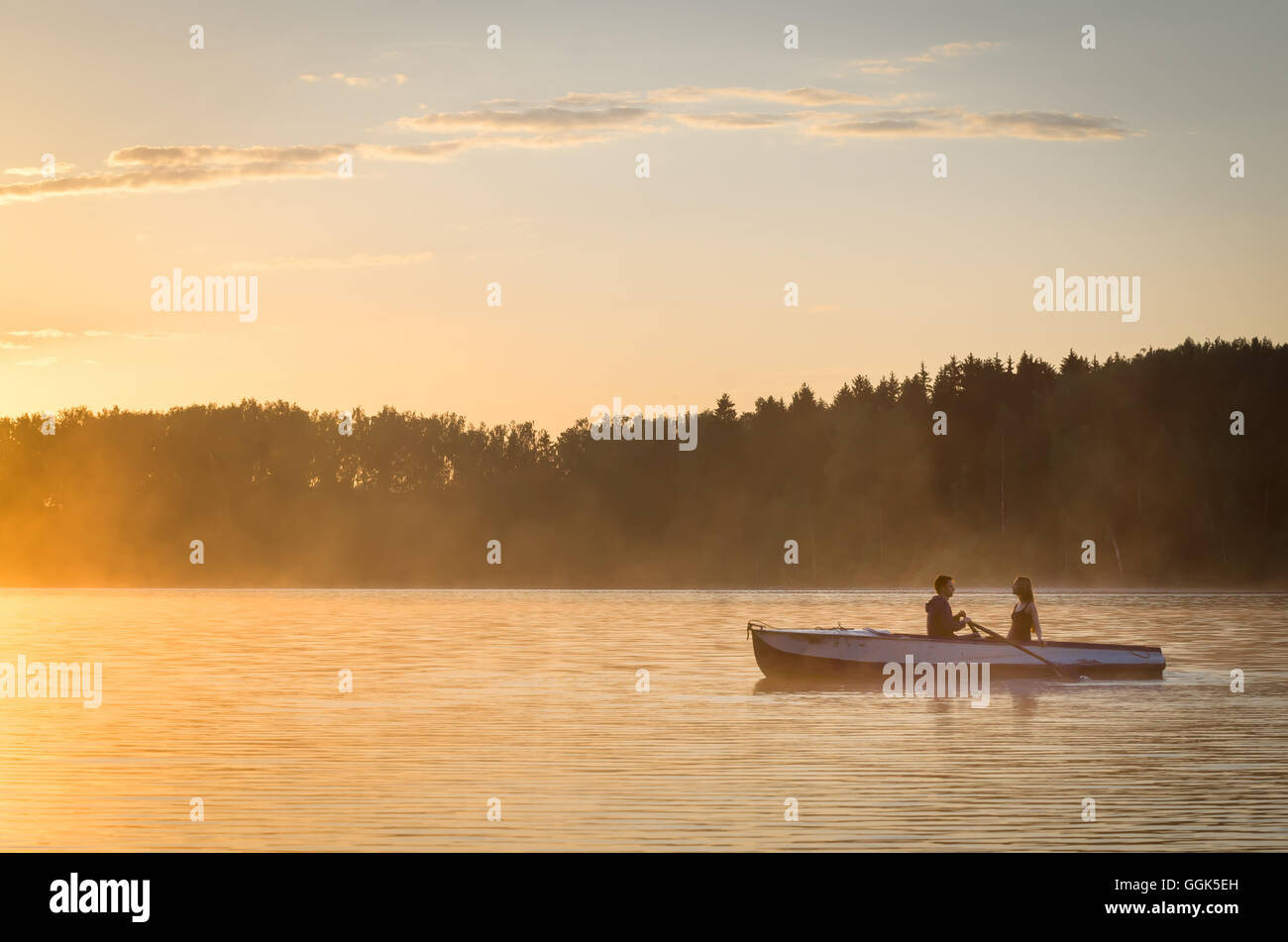 Romantic golden river sunset. Couple on boat backlit by sunlight Stock ...