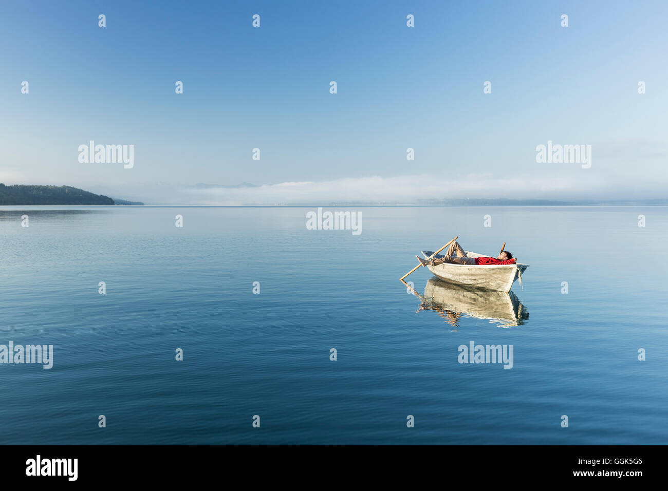 Man lying in boat on lake hi-res stock photography and images - Alamy