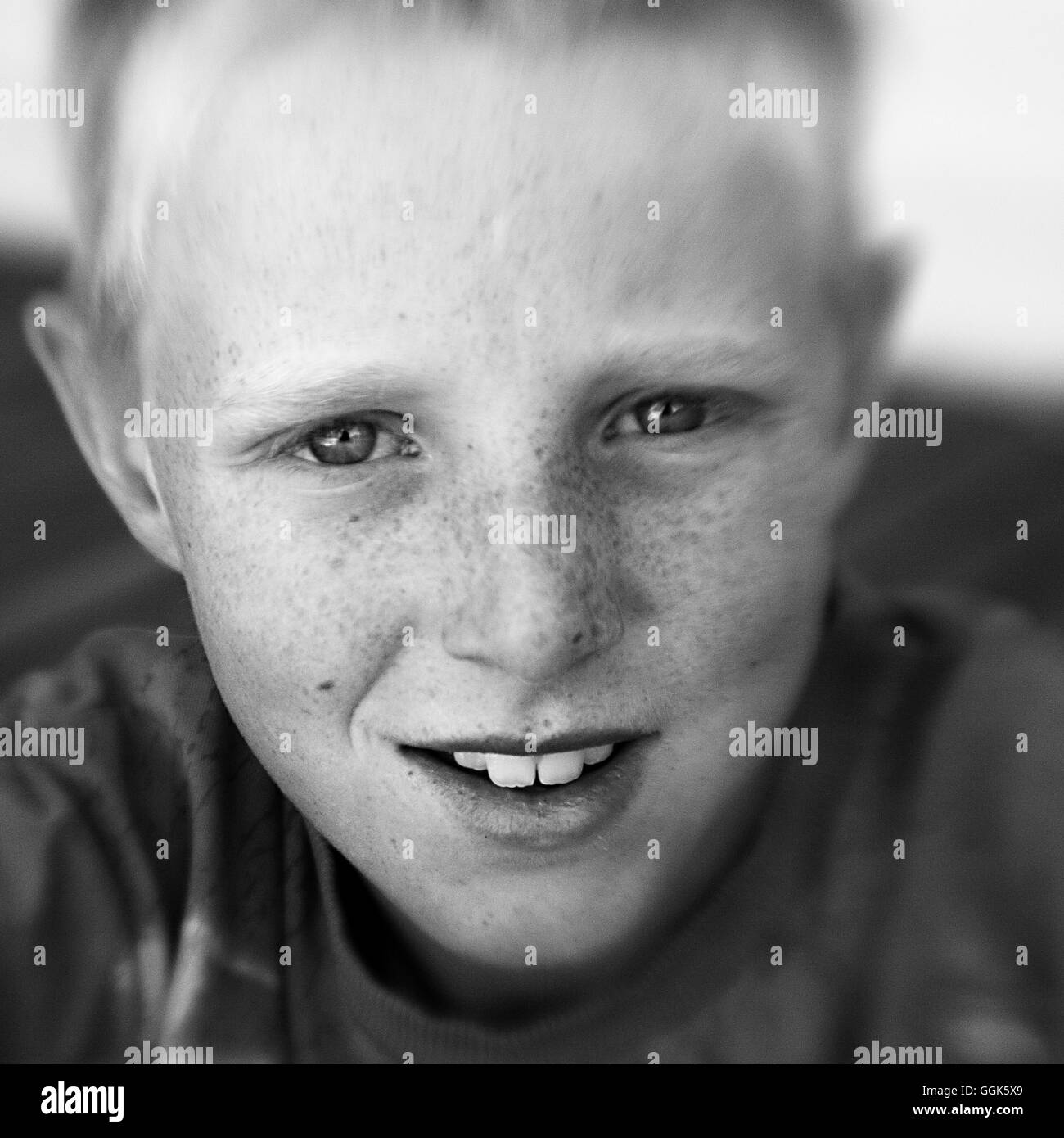 Boy with freckled face looking into the camera (black and white photo ...
