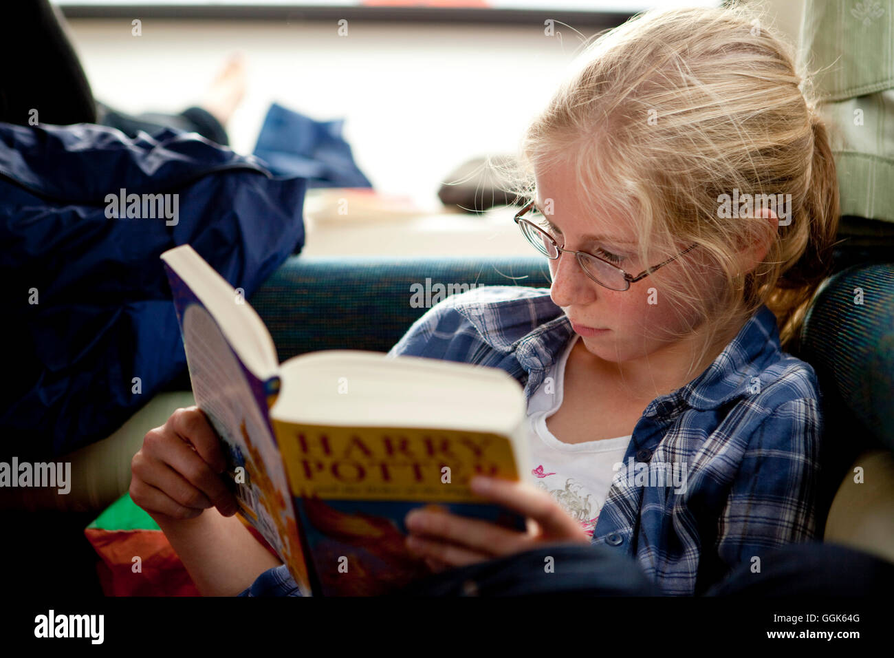 Young girl reading Harry Potter book intensely, Athlone, County Offaly ...