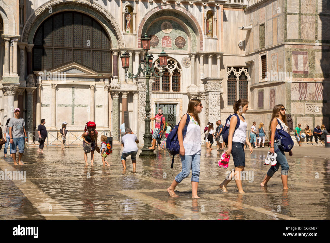 People walking through water of a flooded Piazza San Marco, Venice ...