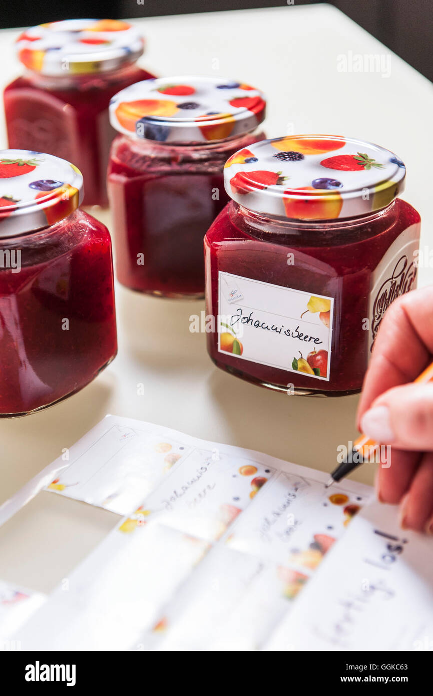 Person labeling jars of jam hi-res stock photography and images - Alamy