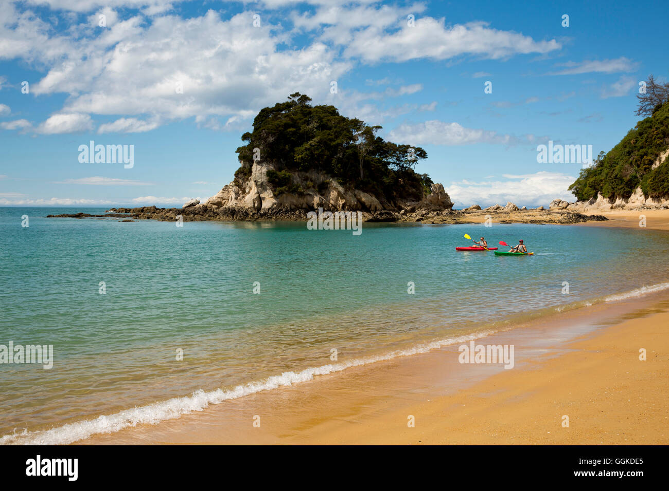 Two kayakers rowing in Tasman Bay near Torlesse Rock at Abel Tasman ...