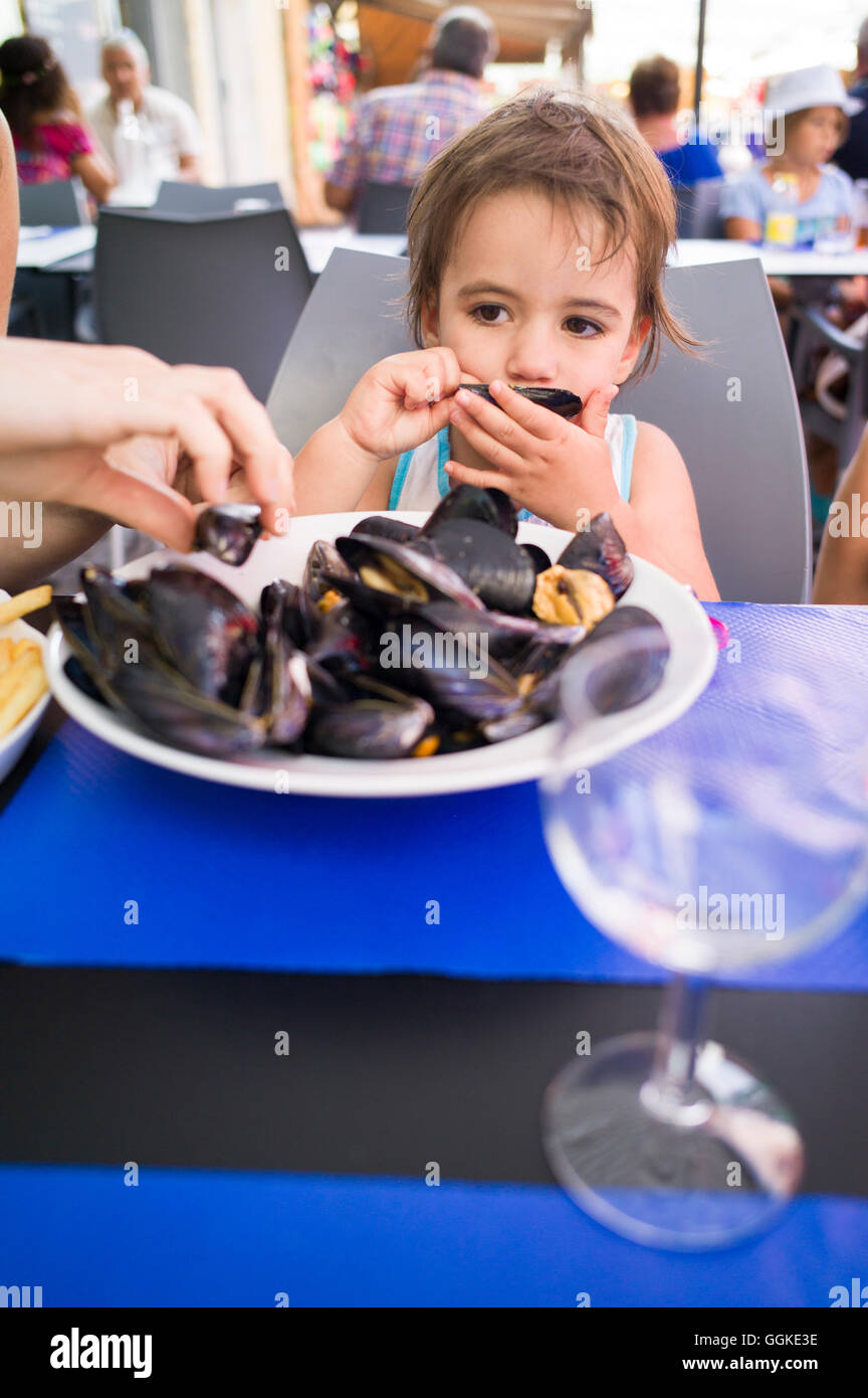 Girl eating mussels hi-res stock photography and images - Alamy