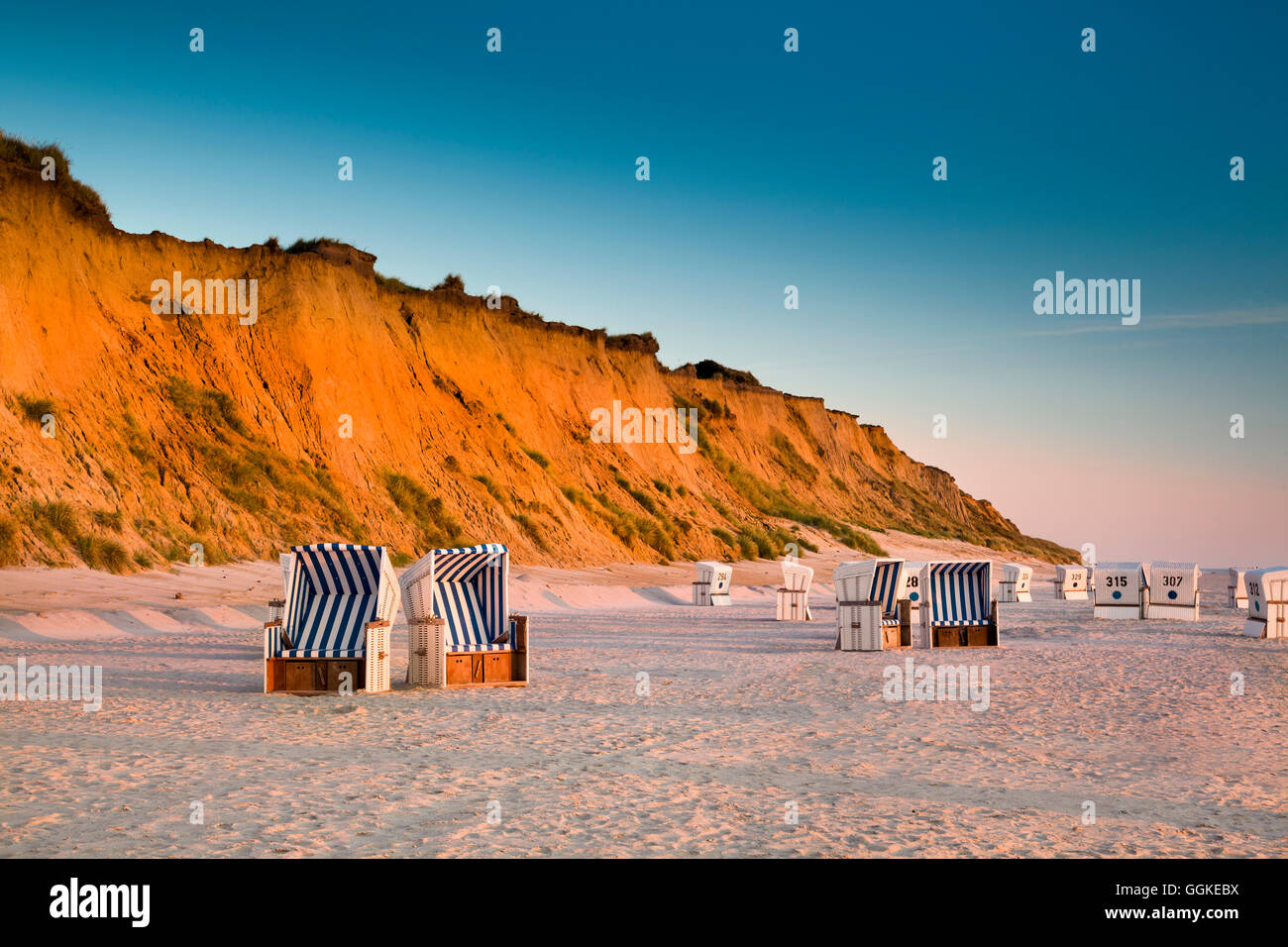 Beach chairs on the beach at sunset, red cliff, Kampen, Sylt Island ...