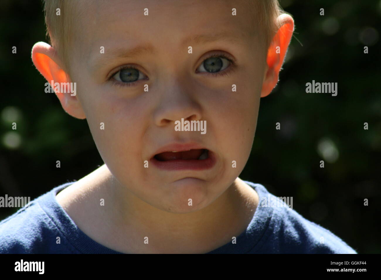 little boy pulling a face, unhappy boy, unhappy child Stock Photo - Alamy