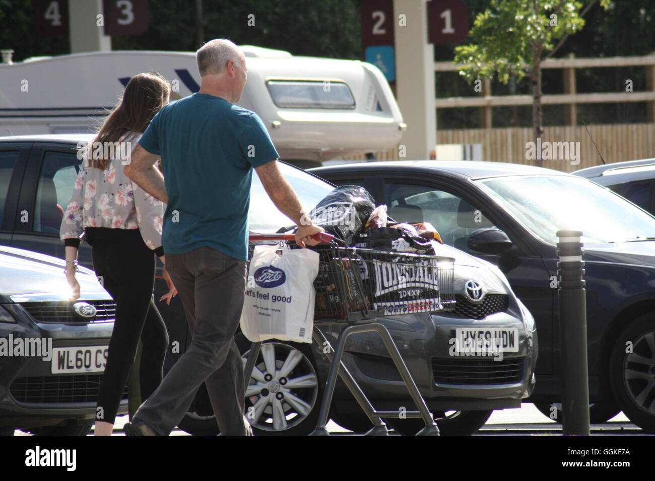 father and daughter shopping, leaving the supermarket, store car park ...
