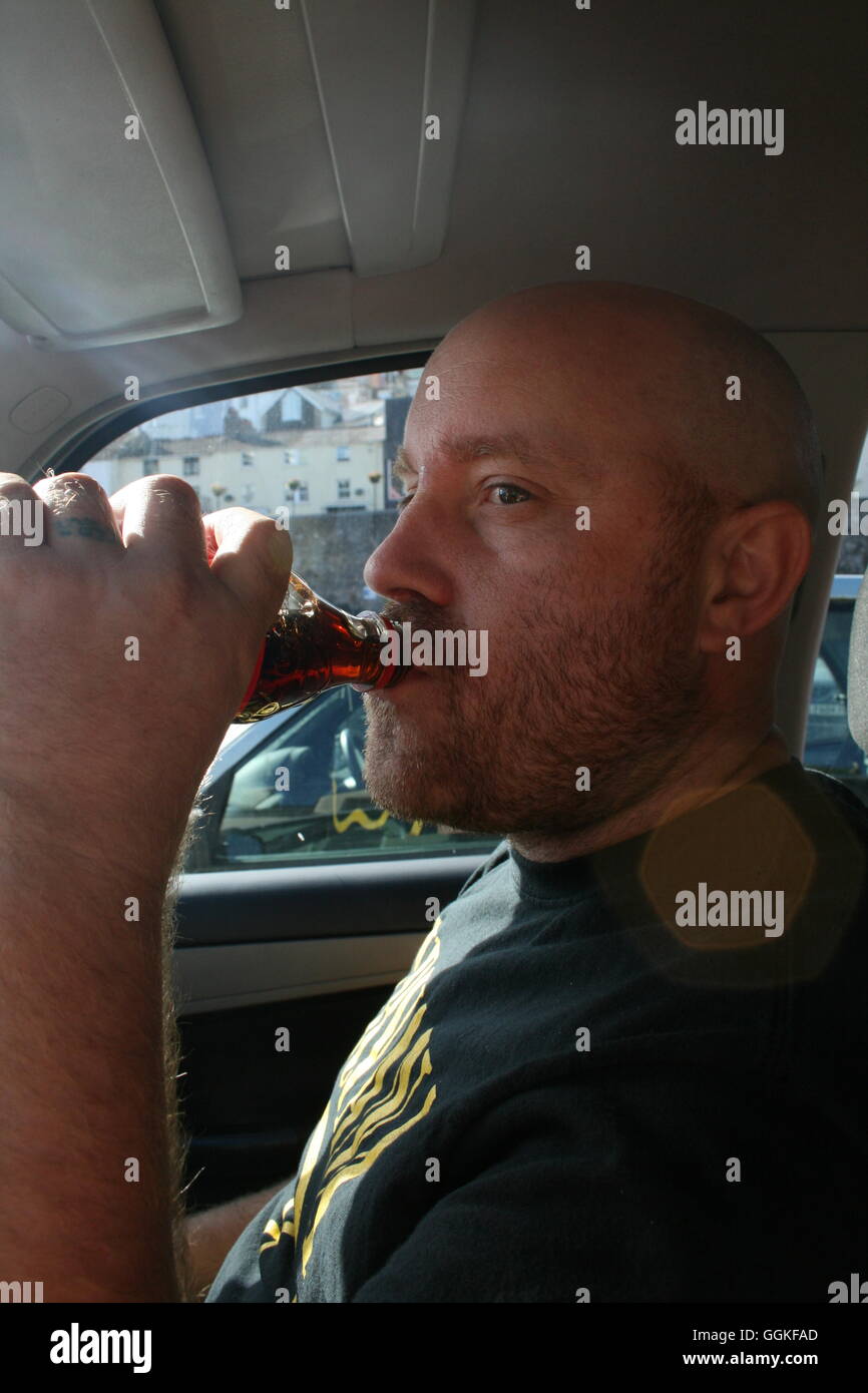 Man drinking in car Stock Photo - Alamy