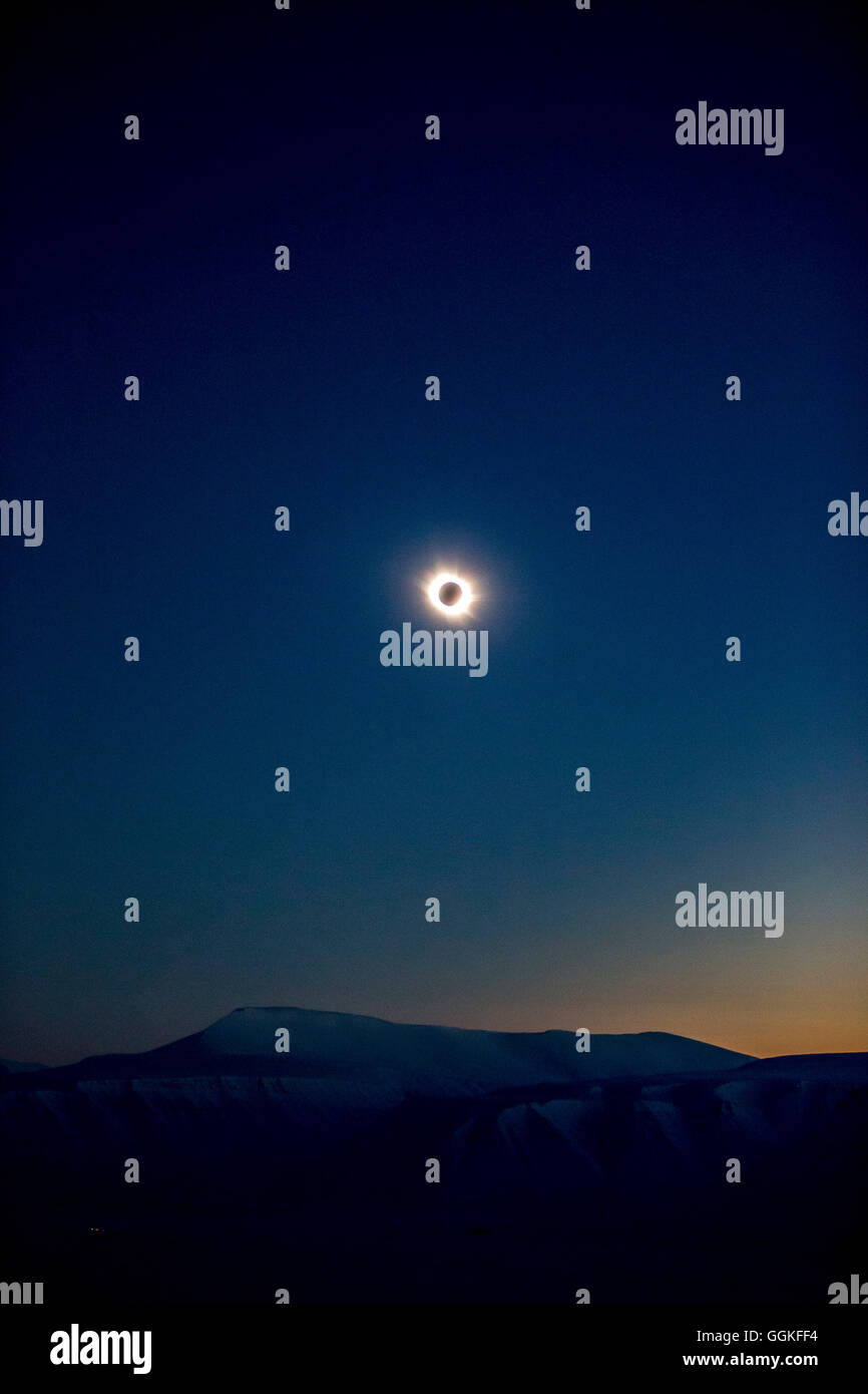 Snowy mountains during the total solar eclipse hi-res stock photography ...