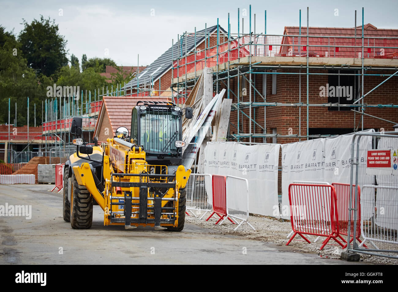 Builder on Building site house building Stock Photo - Alamy