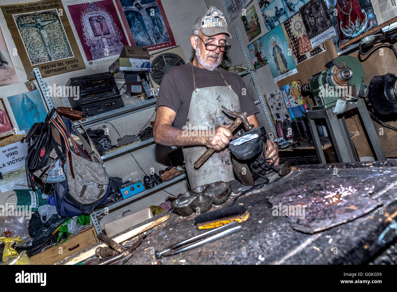 adult male shoemender working at his own workshop Stock Photo - Alamy