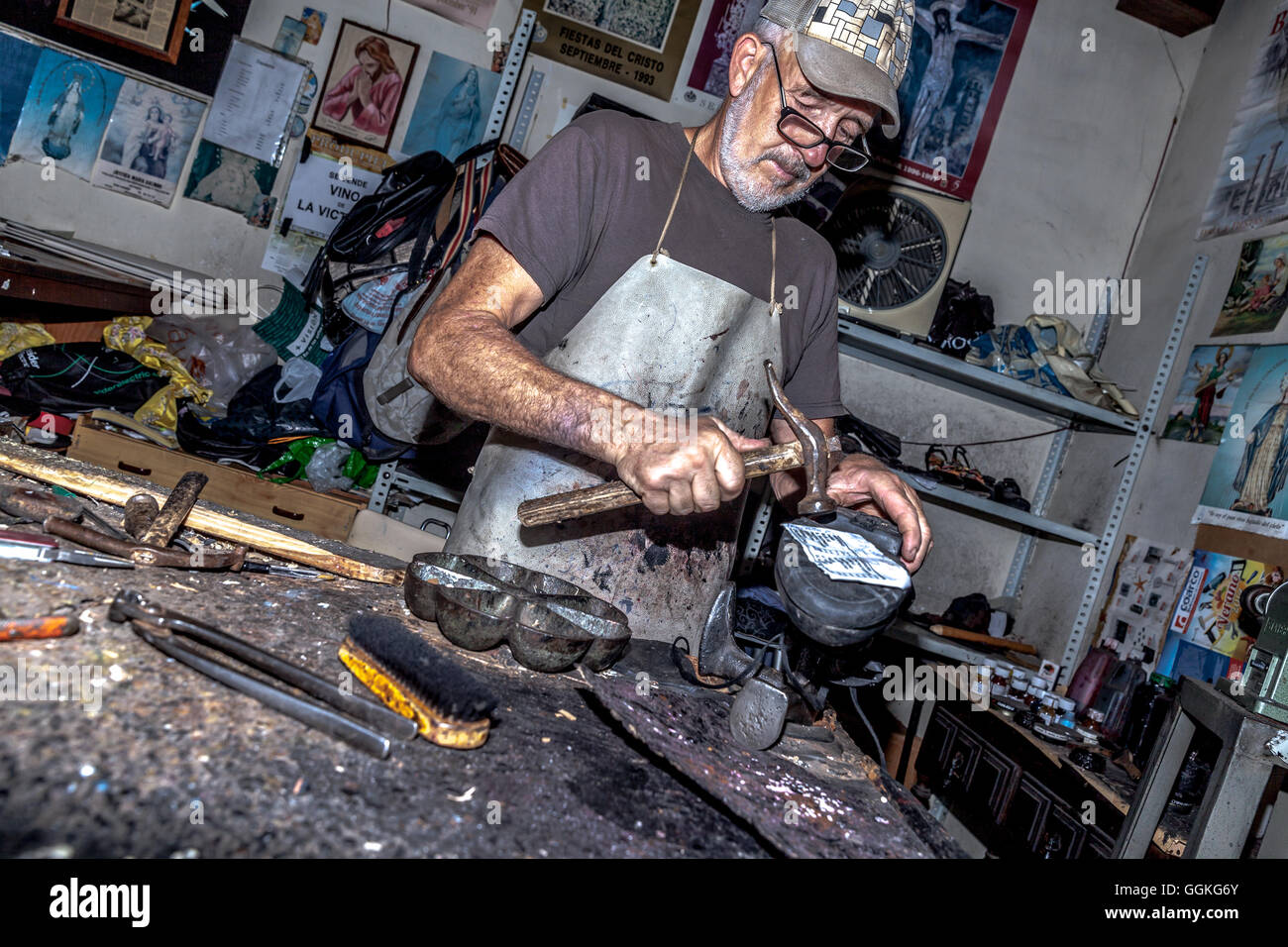 adult male shoemender working at his own workshop Stock Photo - Alamy