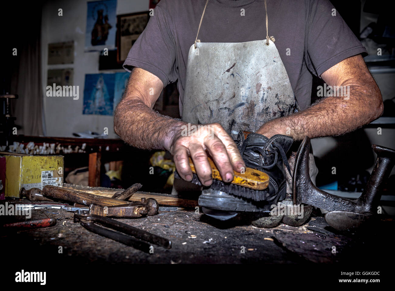 adult male shoemender working at his own workshop Stock Photo - Alamy