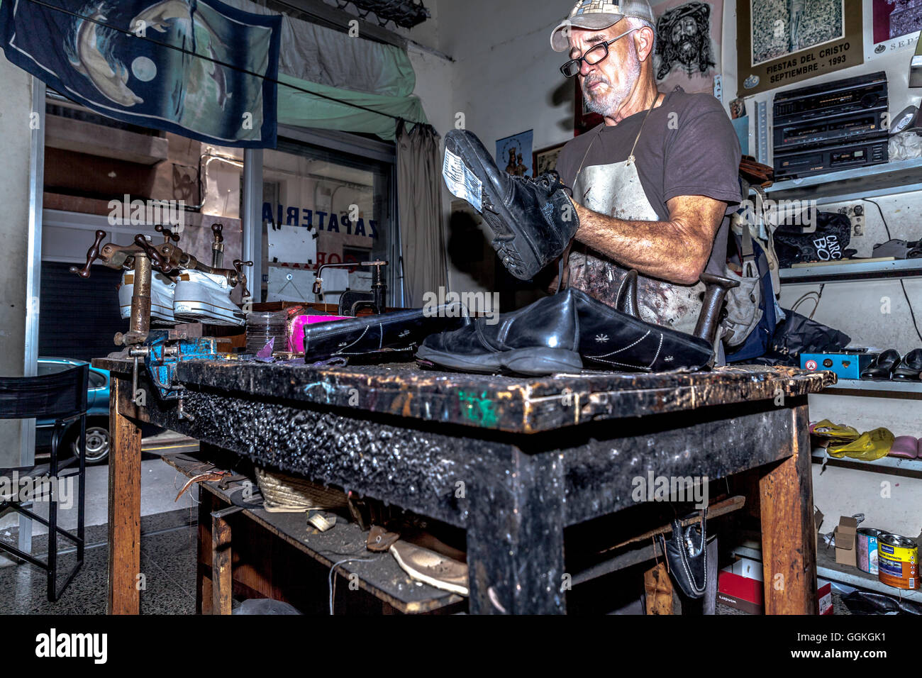 adult male shoemender working at his own workshop Stock Photo - Alamy