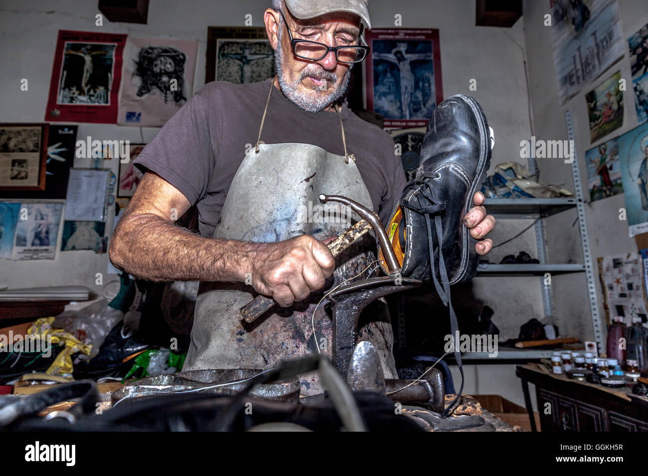 adult male shoemender working at his own workshop Stock Photo - Alamy