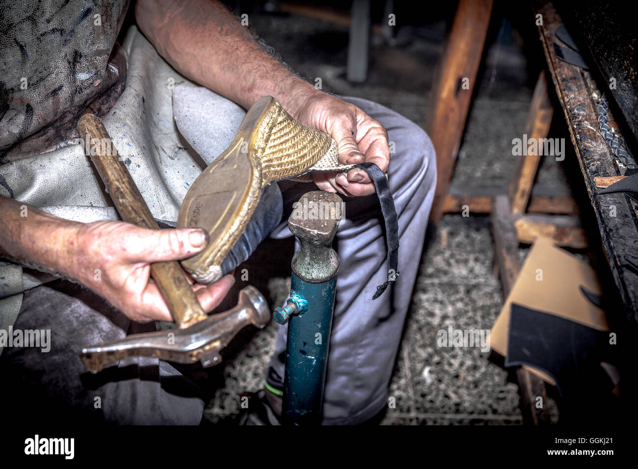 adult male shoemender working at his own workshop Stock Photo - Alamy
