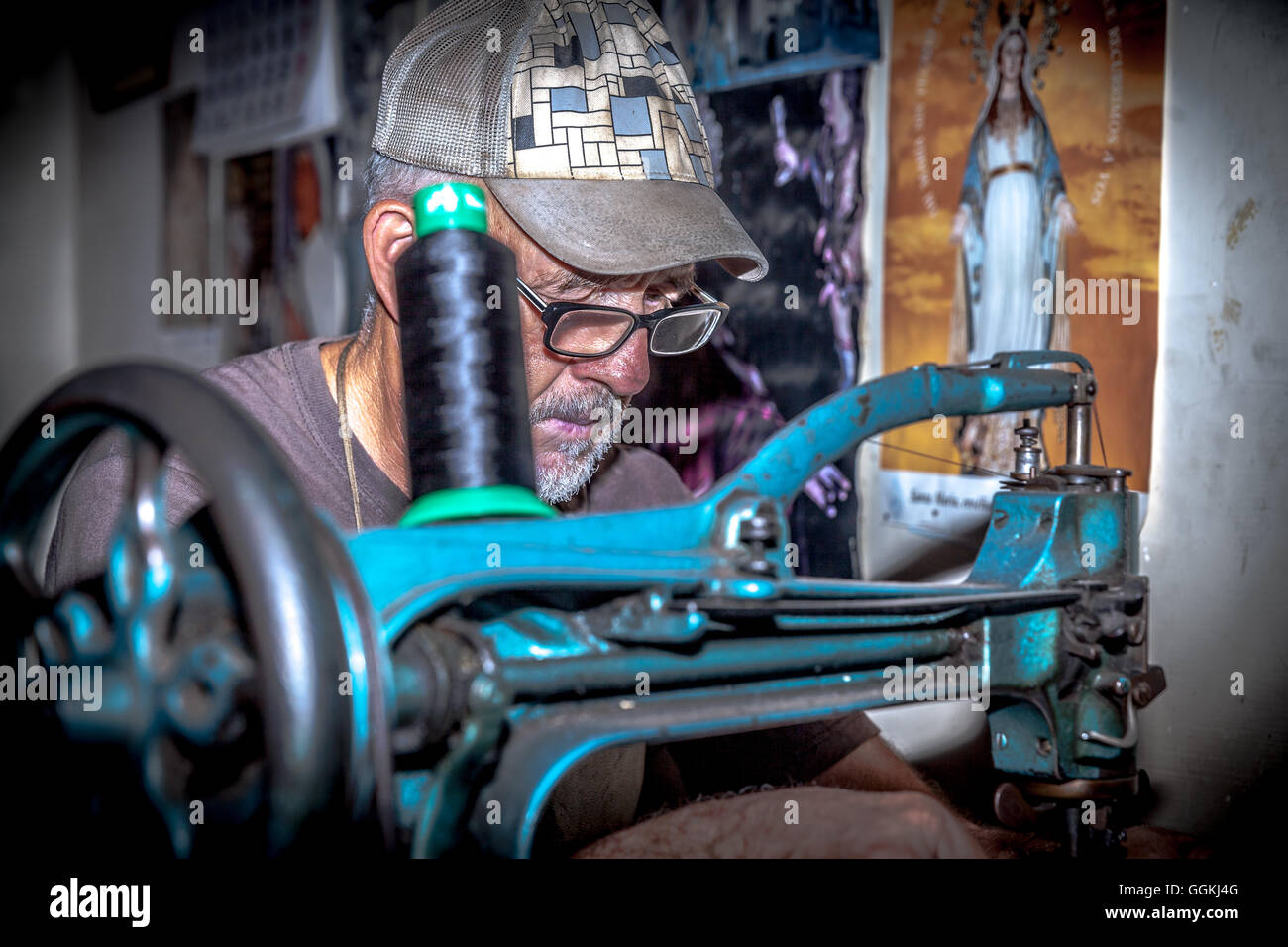 adult male shoemender working at his own workshop Stock Photo - Alamy