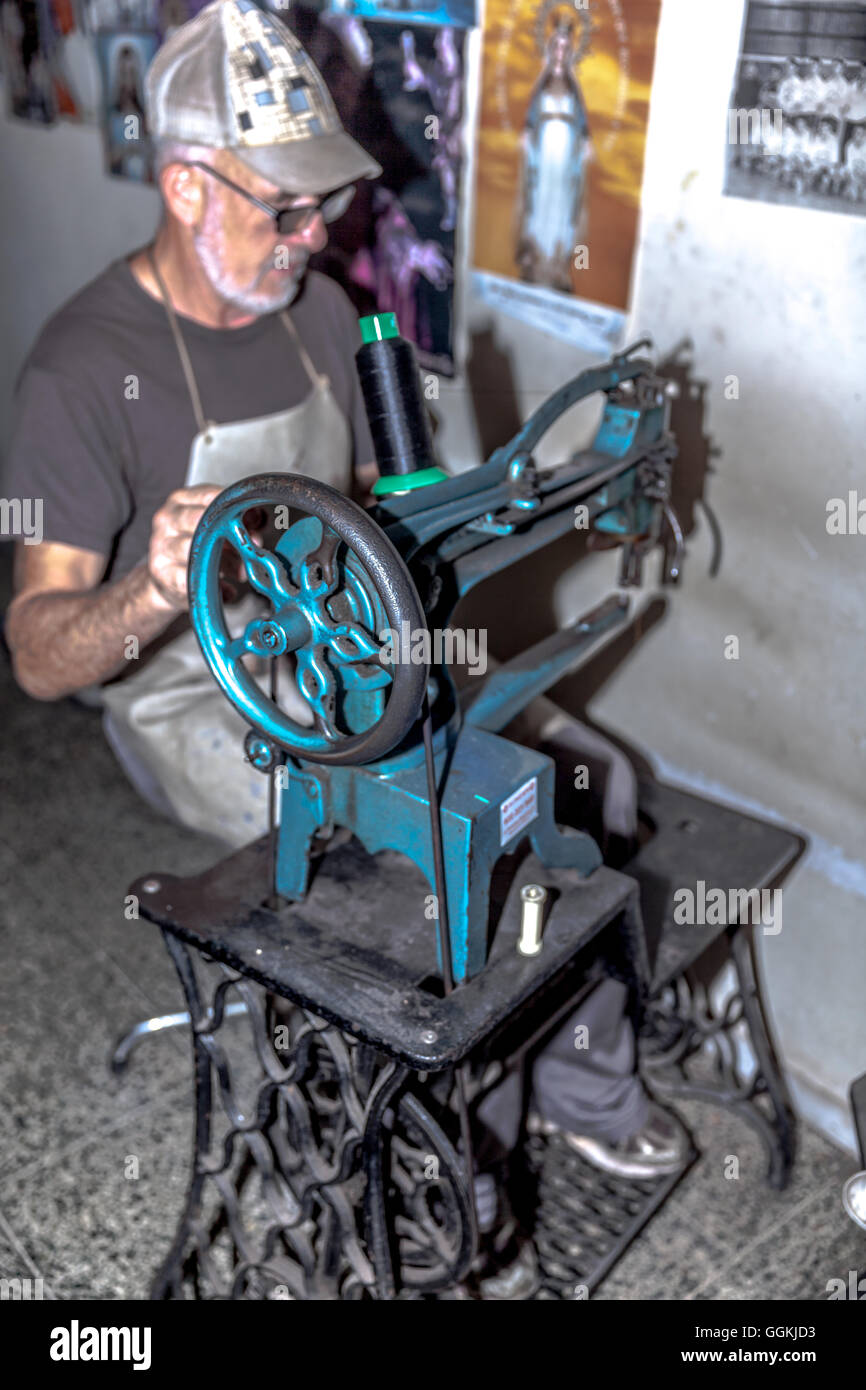 adult male shoemender working at his own workshop Stock Photo - Alamy