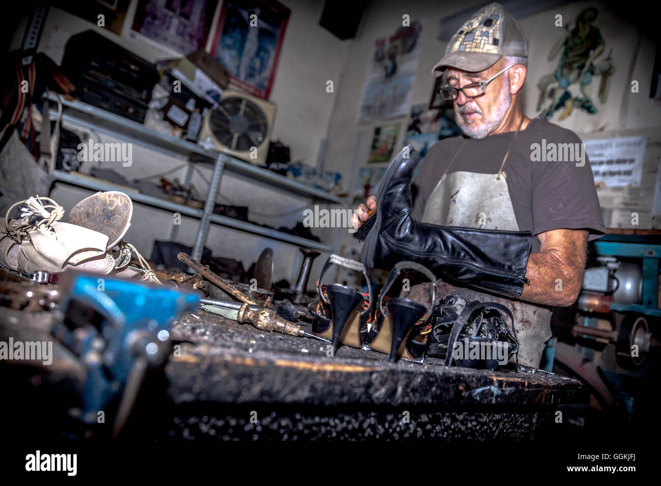 adult male shoemender working at his own workshop Stock Photo - Alamy