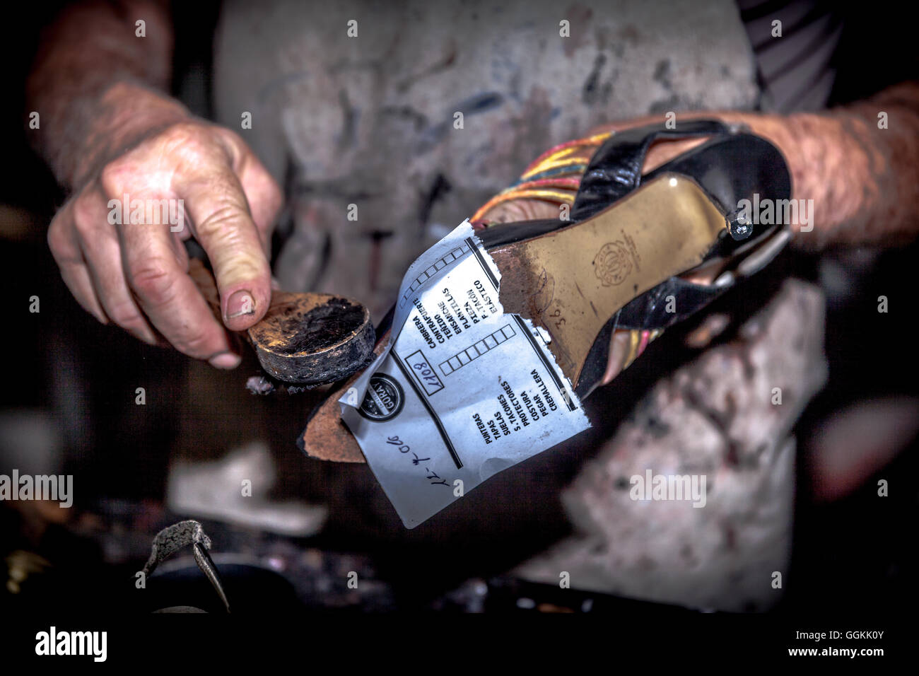 adult male shoemender working at his own workshop Stock Photo - Alamy